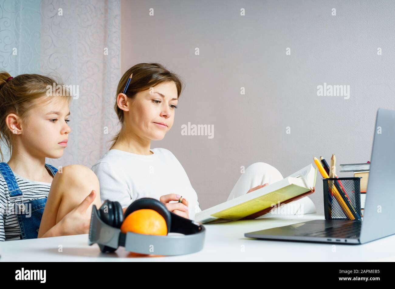 Mother and daughter doing homework together Stock Photo - Alamy