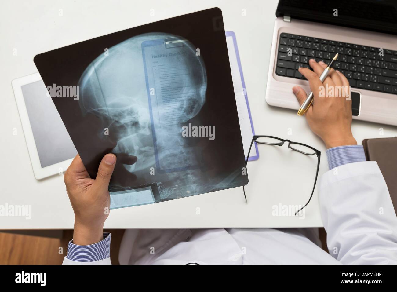 Doctor diagnose and analyze on x-ray film of patient. Top view shot ...
