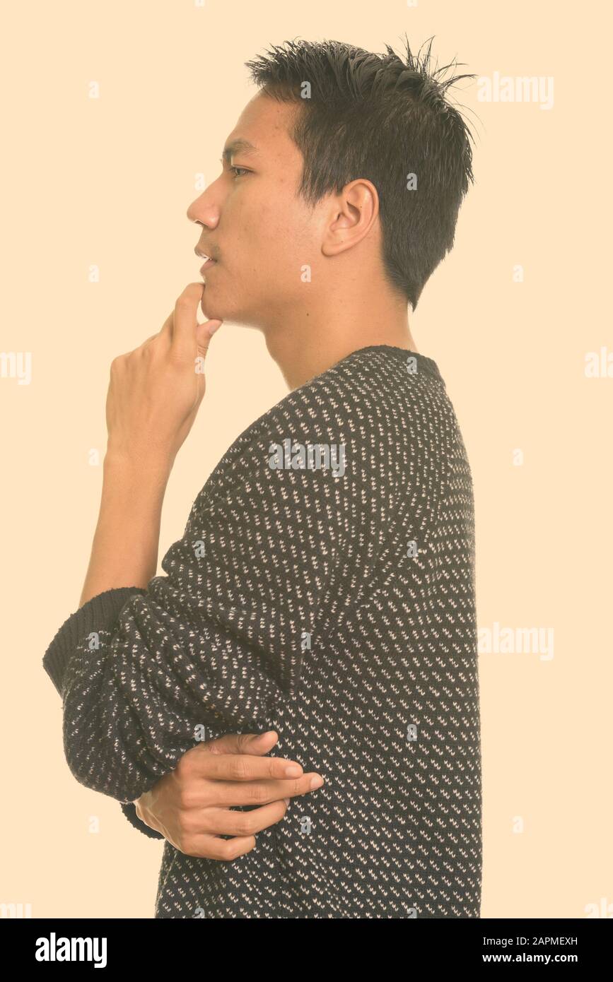 Profile view of young Asian man thinking Stock Photo - Alamy