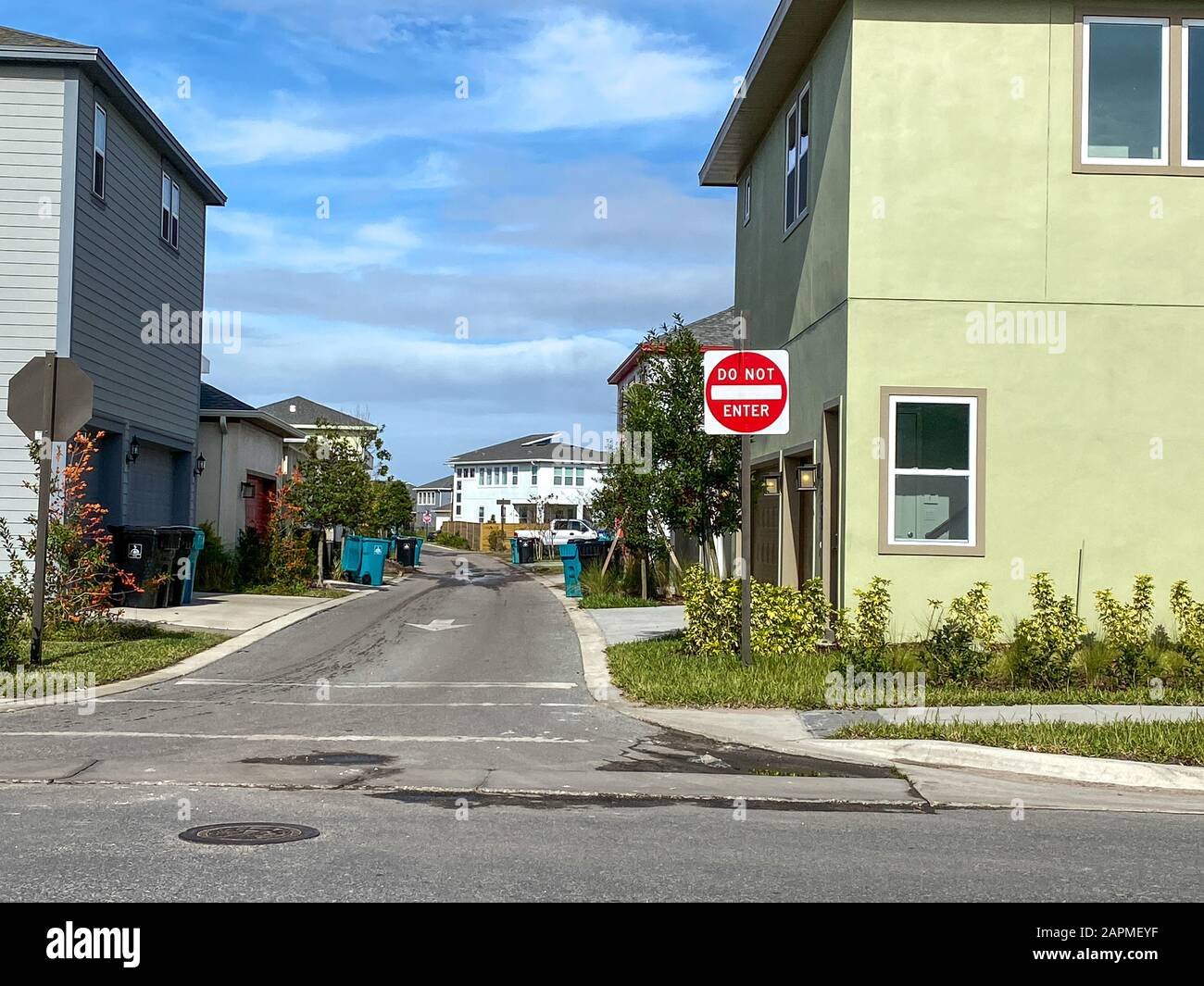 Orlando, FL/USA-1/23/20: An alley behind houses with garbage cans out ...