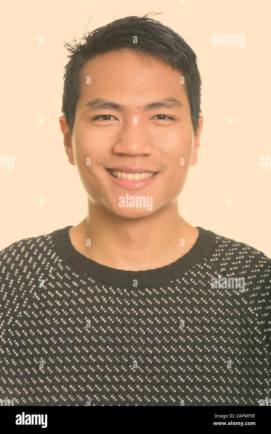 Face of young happy Asian man smiling Stock Photo - Alamy