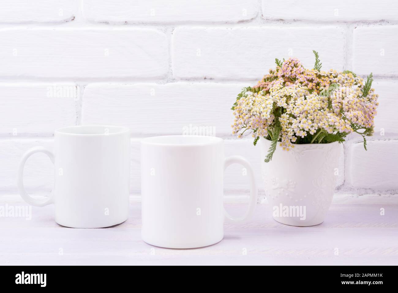 Two white coffee mug mockup with pink beige wild flowers in the vase ...