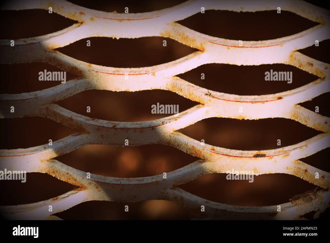Old rusty iron grid illuminated by the sun close up. Abstract ...