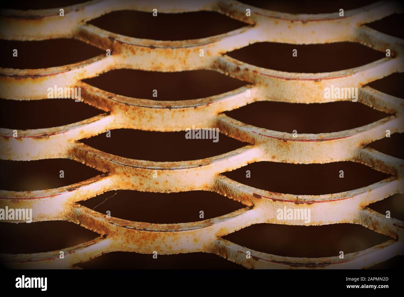 Old rusty iron grid illuminated by the sun close up. Abstract ...