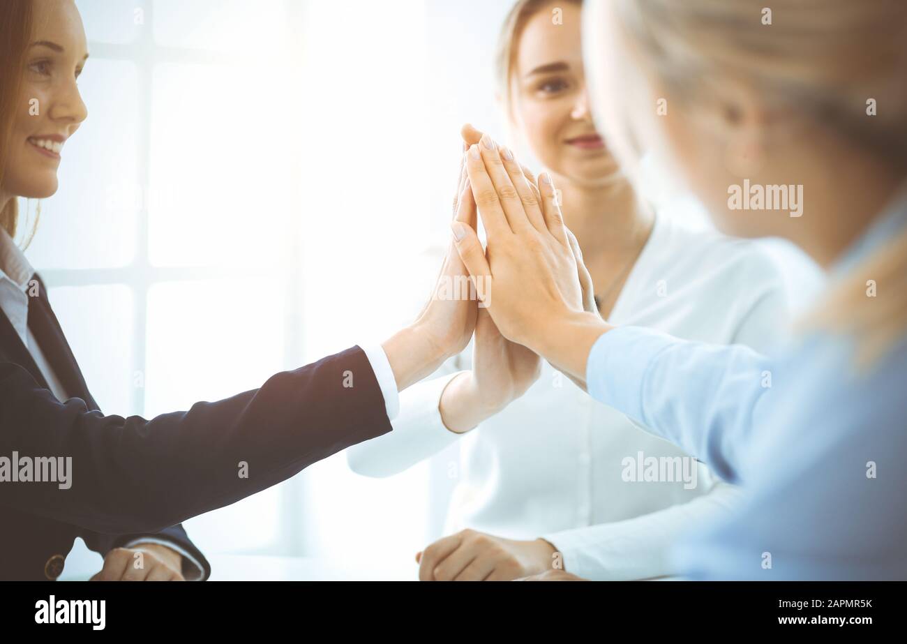 Business people happy showing teamwork and giving five showing unity ...