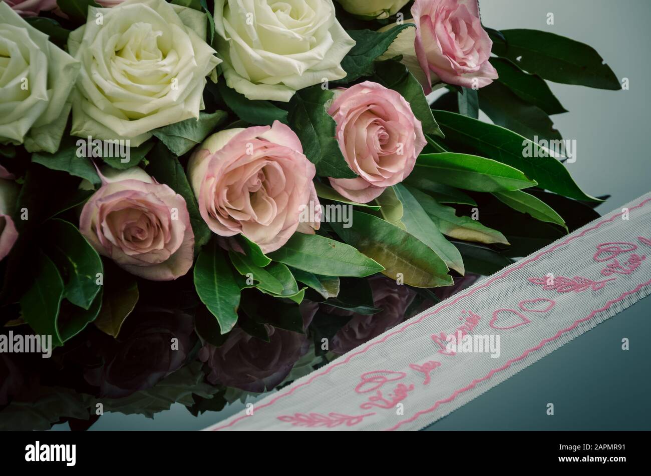 Detail of red rose on the table Stock Photo - Alamy