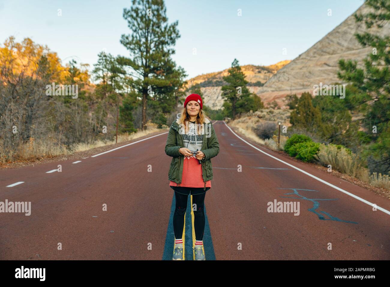 girl stands on the road in Zion National Park in southwestern Utah near ...