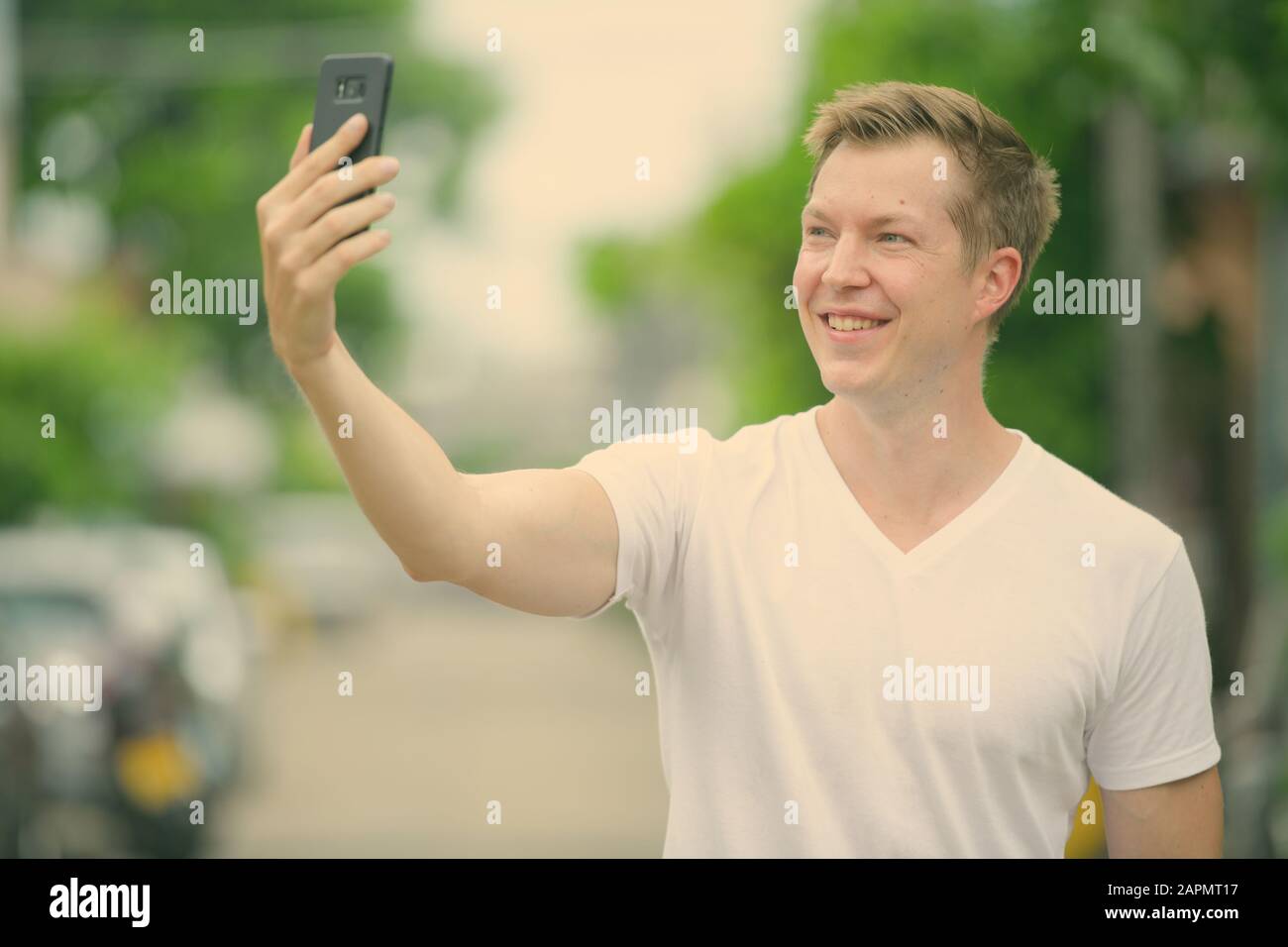 Portrait of young handsome man in the streets outdoors Stock Photo - Alamy
