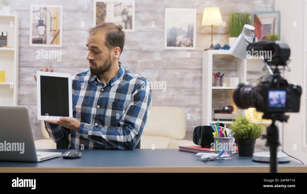 Famous young influencer filming review of tablet. Creative content ...