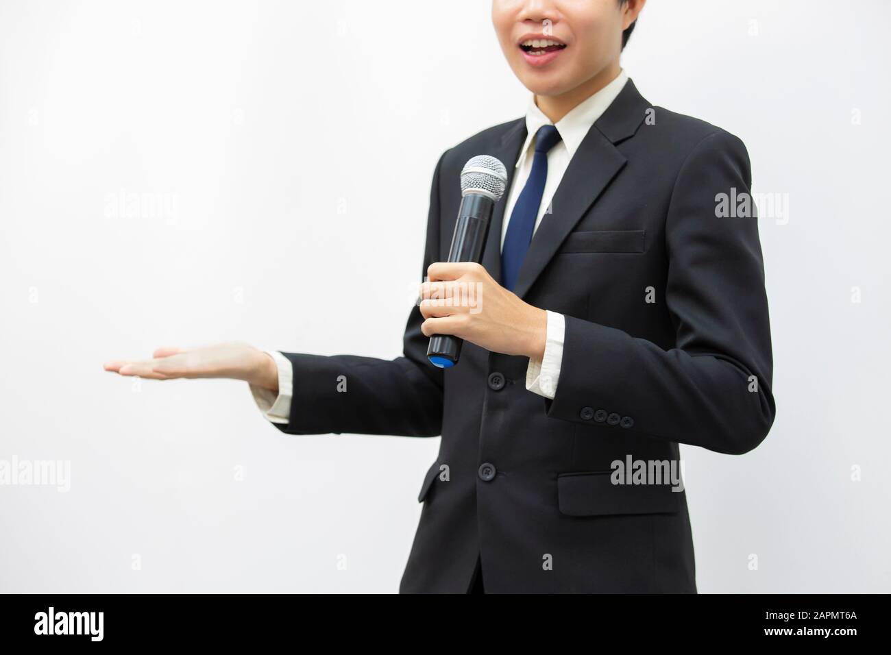 Business man smiling, speaking holding microphone at conference Stock ...