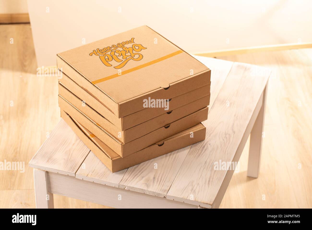 Pizza boxes on wooden table hi-res stock photography and images - Alamy