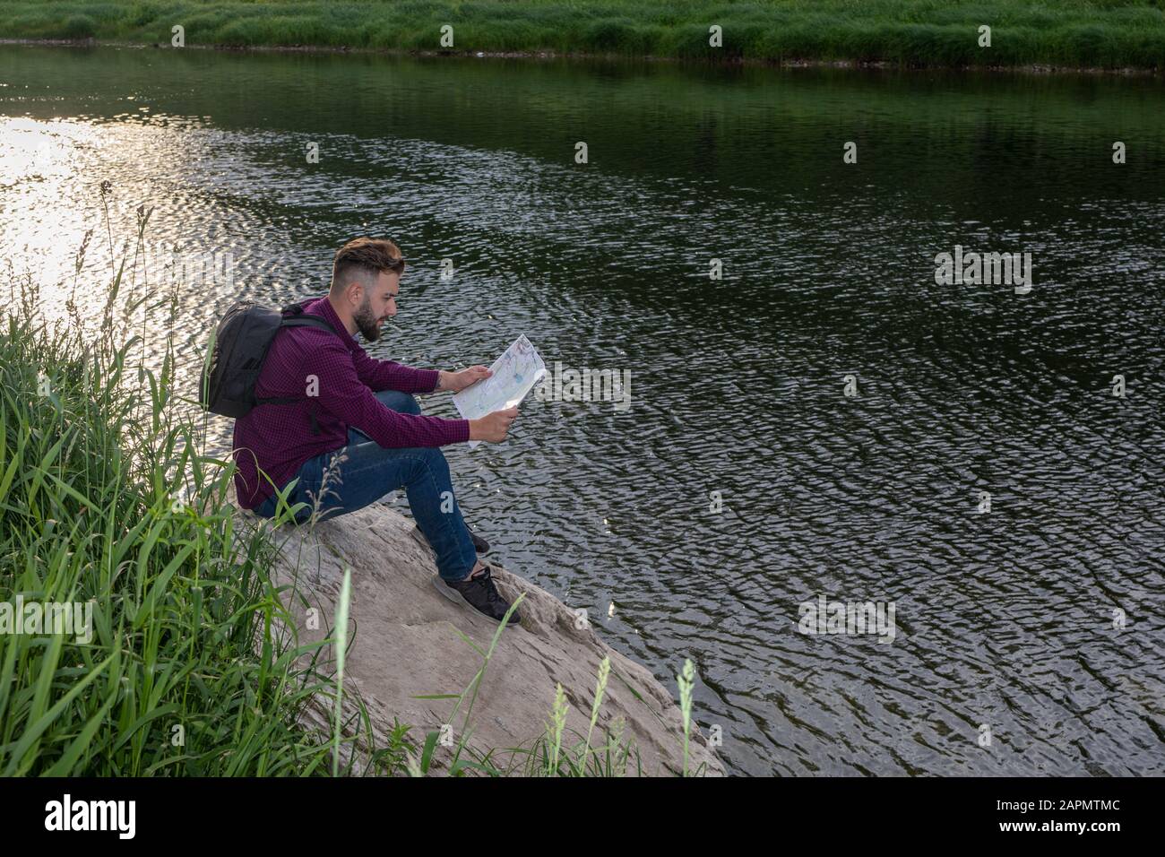 Man with map searching directions in wilderness area. Tourist with ...