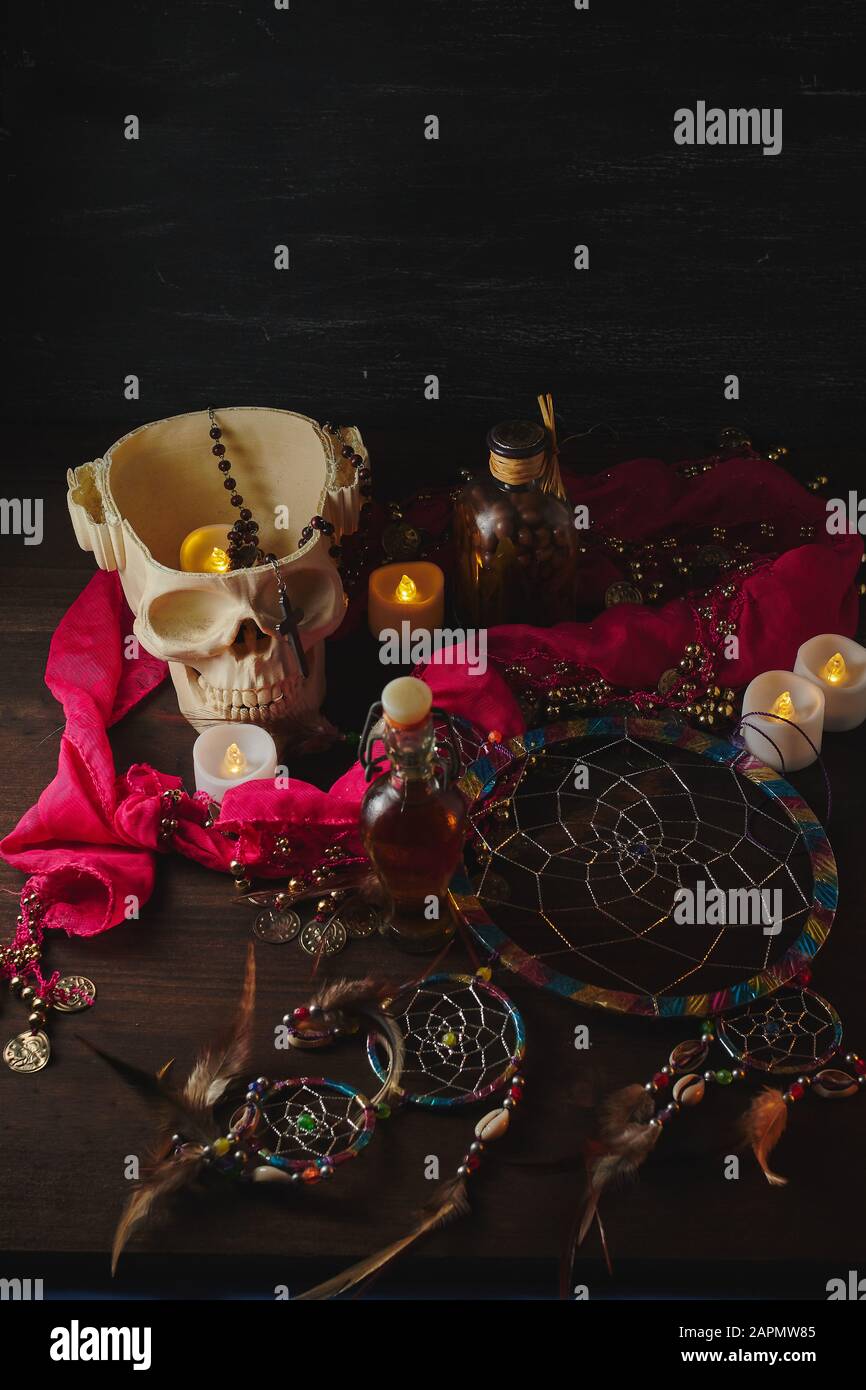 Scary still life with potions, skull, mortar, vintage bottles and ...