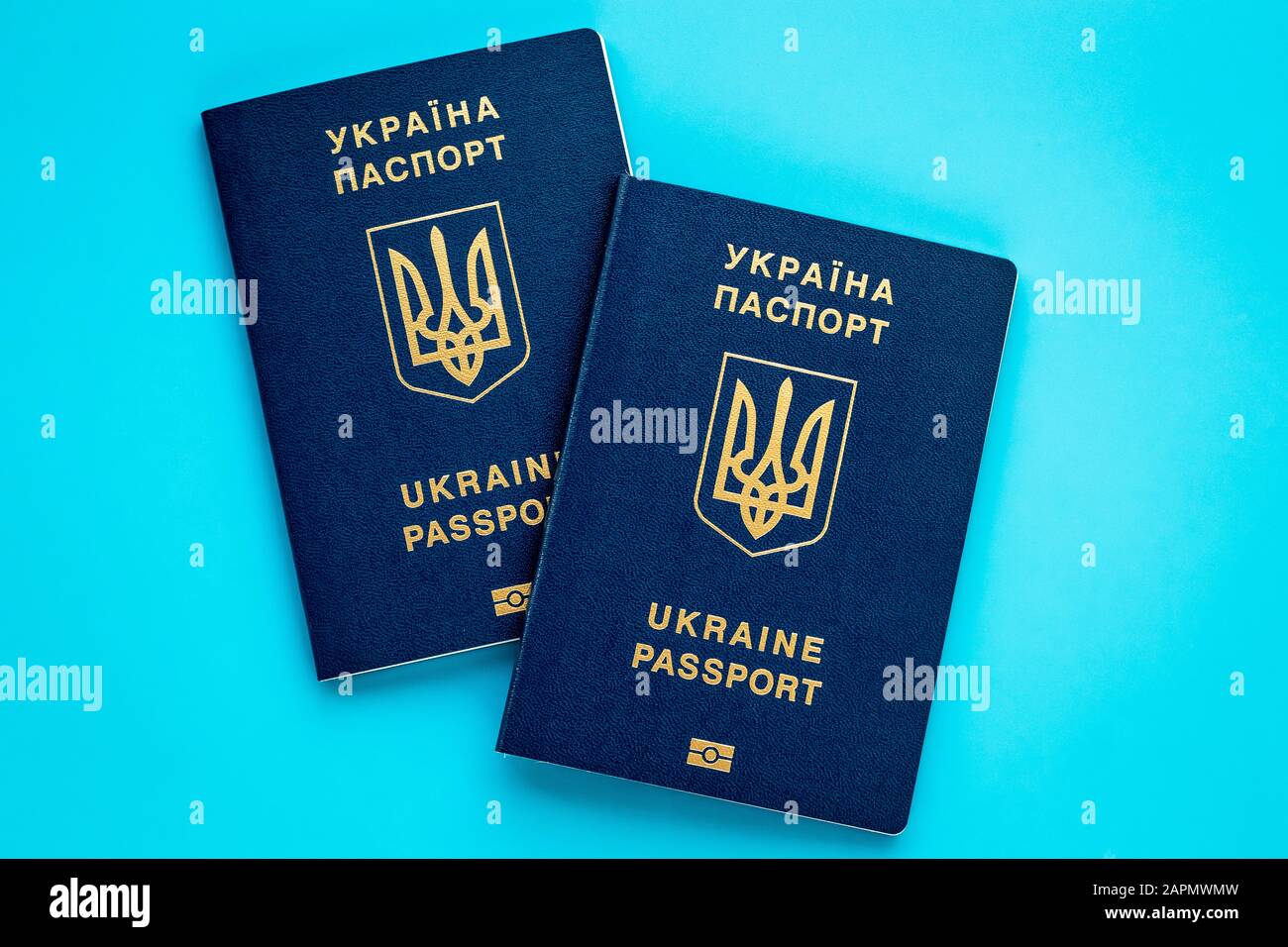Two ukrainian biometric passports on blue background. Planning vacation ...