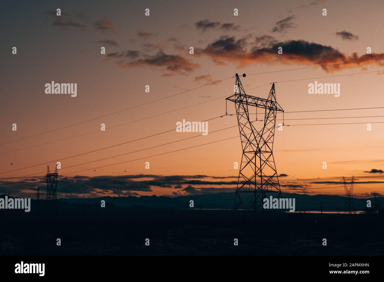 Electric transmission lines against a background of sunset over ...