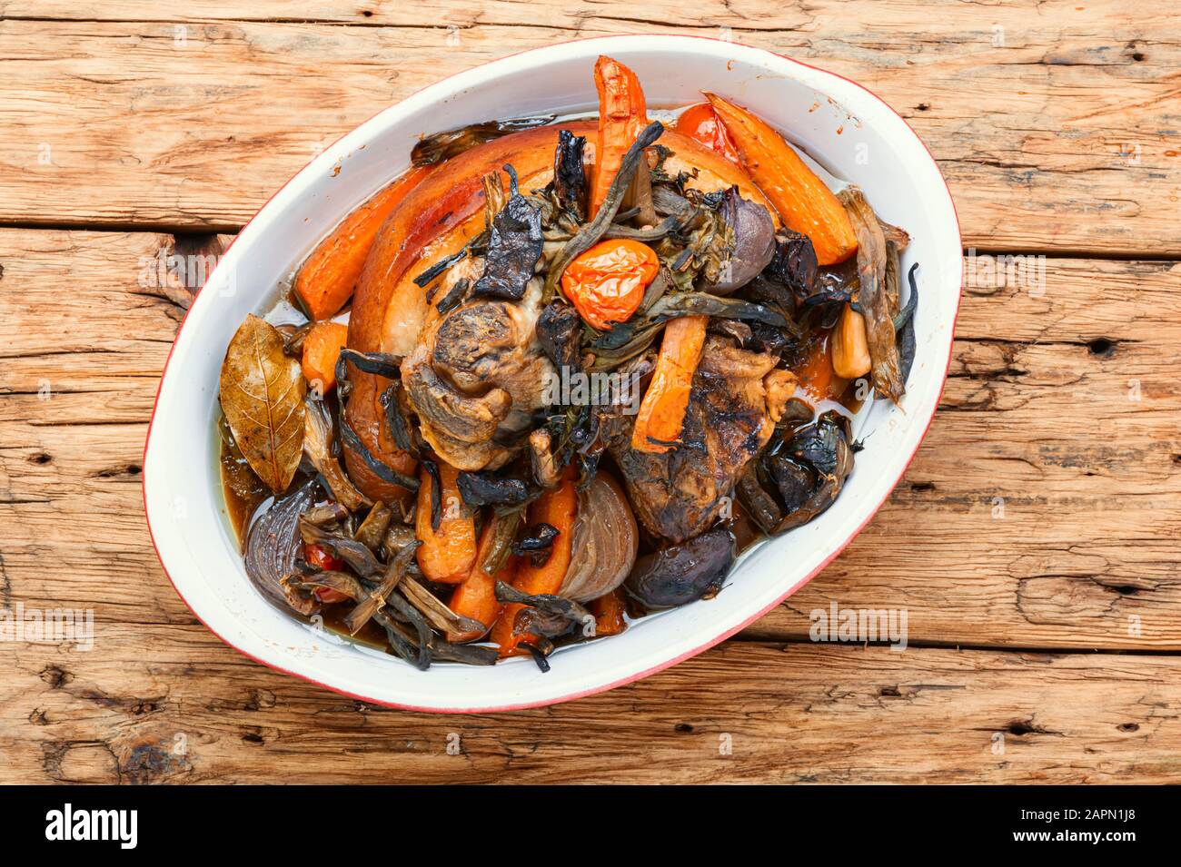 Roasted pork knuckle eisbein with vegetables on wooden background ...