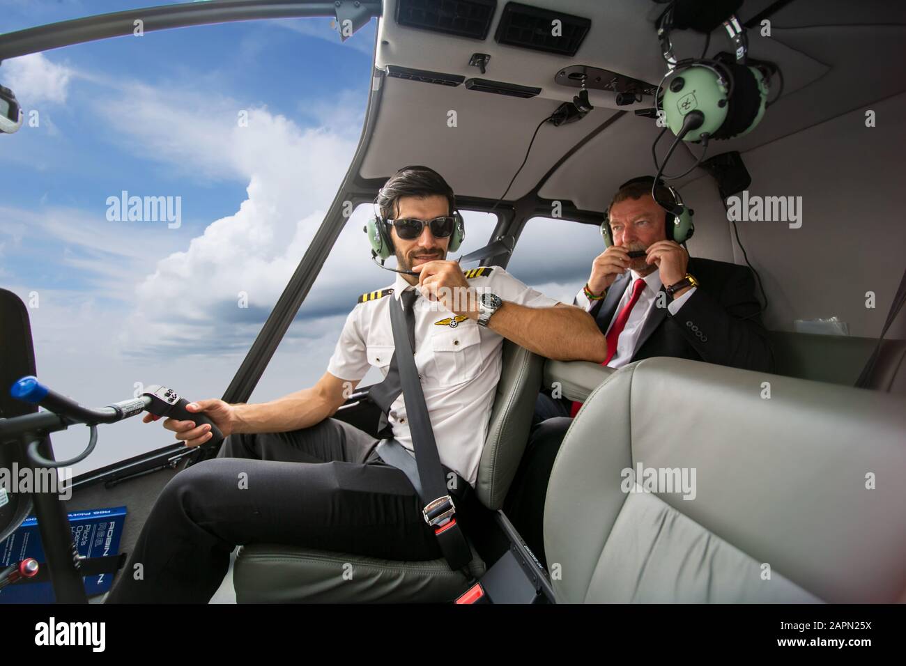 Business people traveling by helicopter , Shot of a mature businessman ...