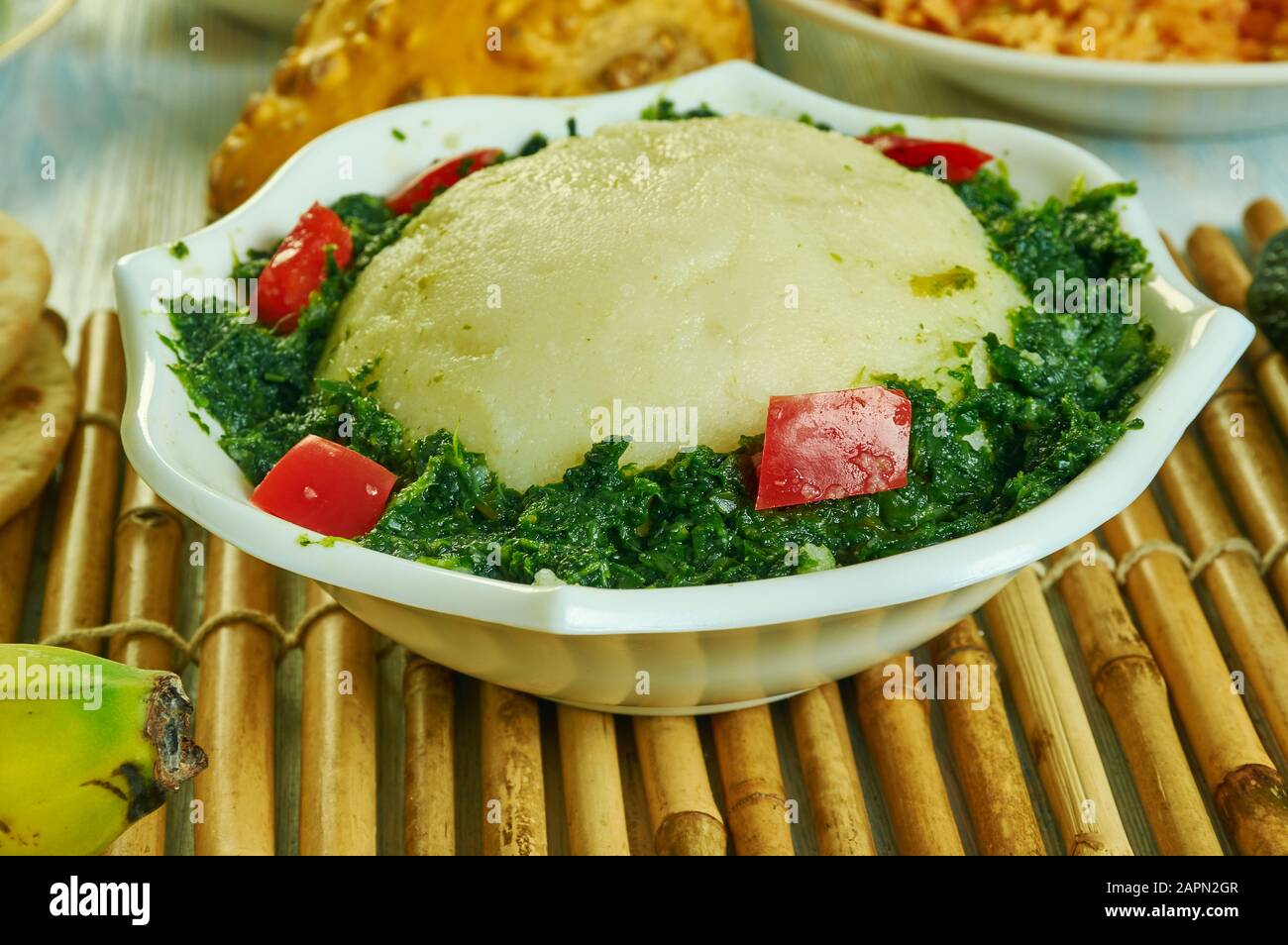 Ugali Sukuma Wiki, made with collard greens, known as sukuma, cooked ...