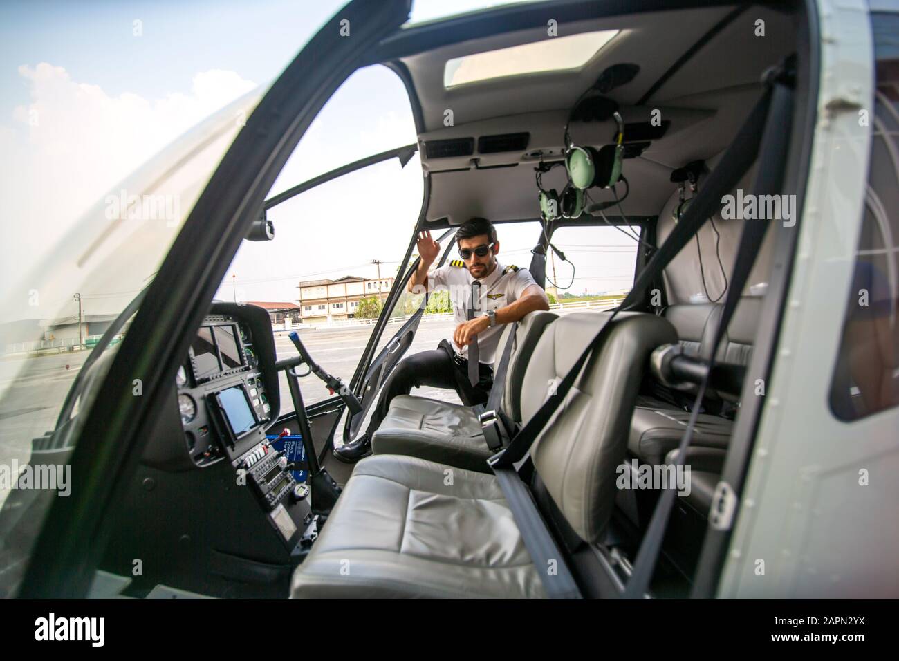 Shot of a mature Helicopter pilot using a headset while traveling in a ...