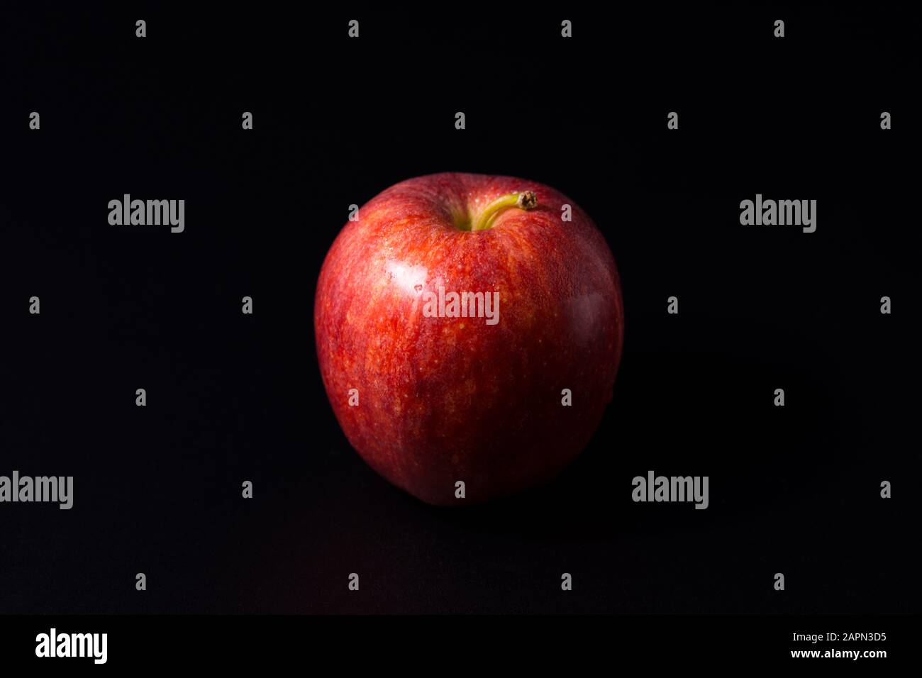 Red apple isolated on a black background Stock Photo - Alamy