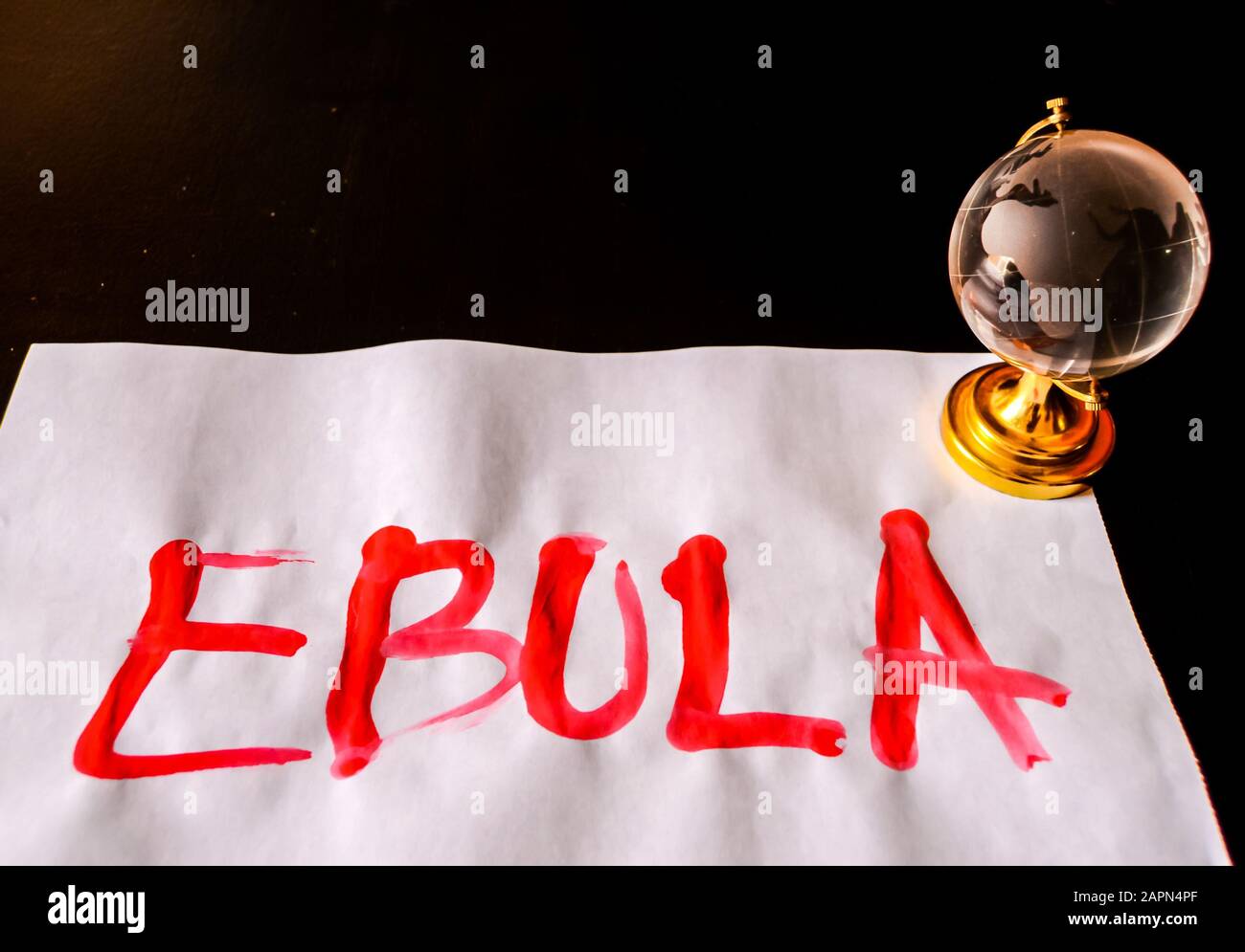 Word "EBULA" written on a piece of white paper with a 3D globe model in ...