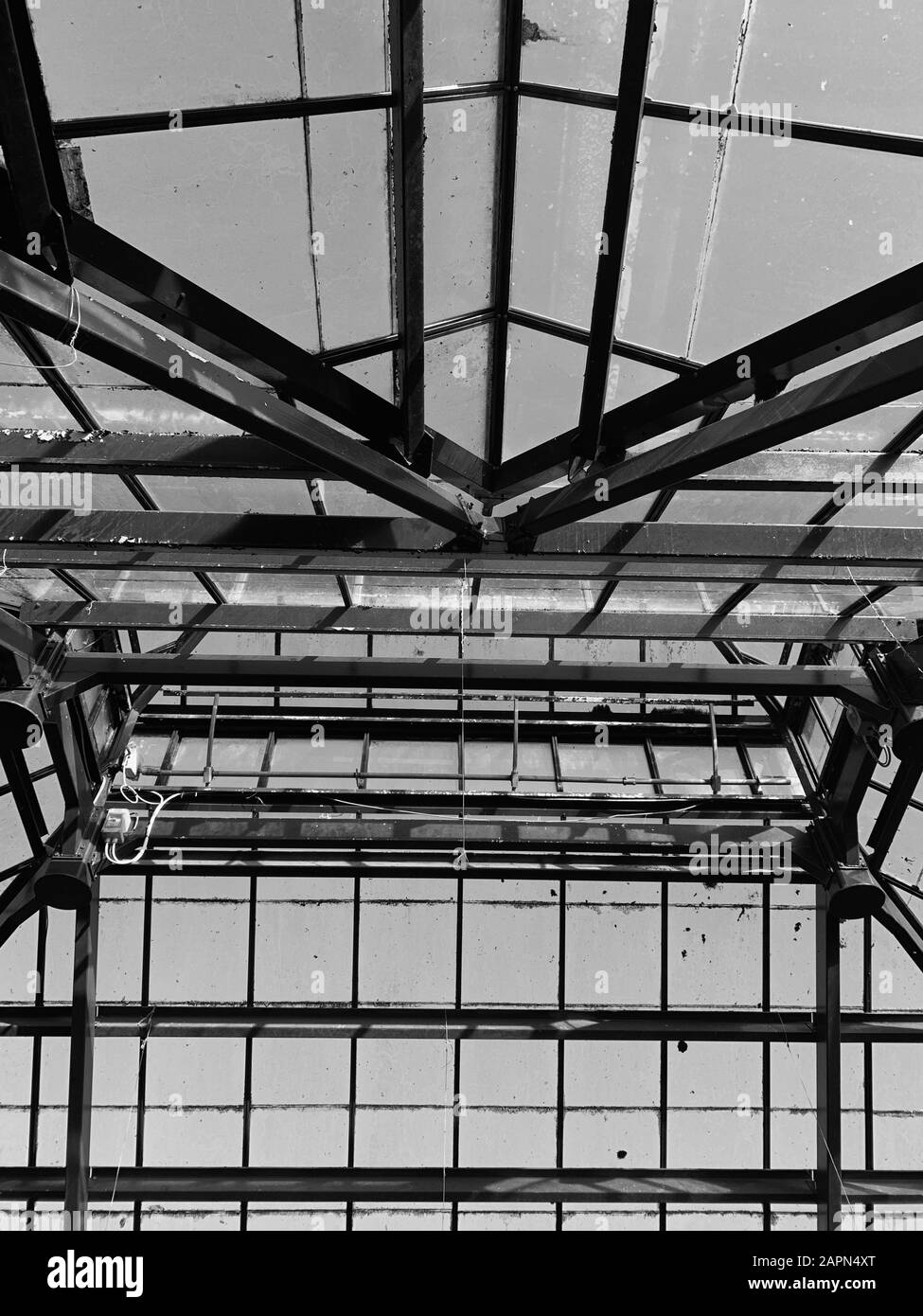 Low angle shot of a roof of a building made of glass and lots of metal ...