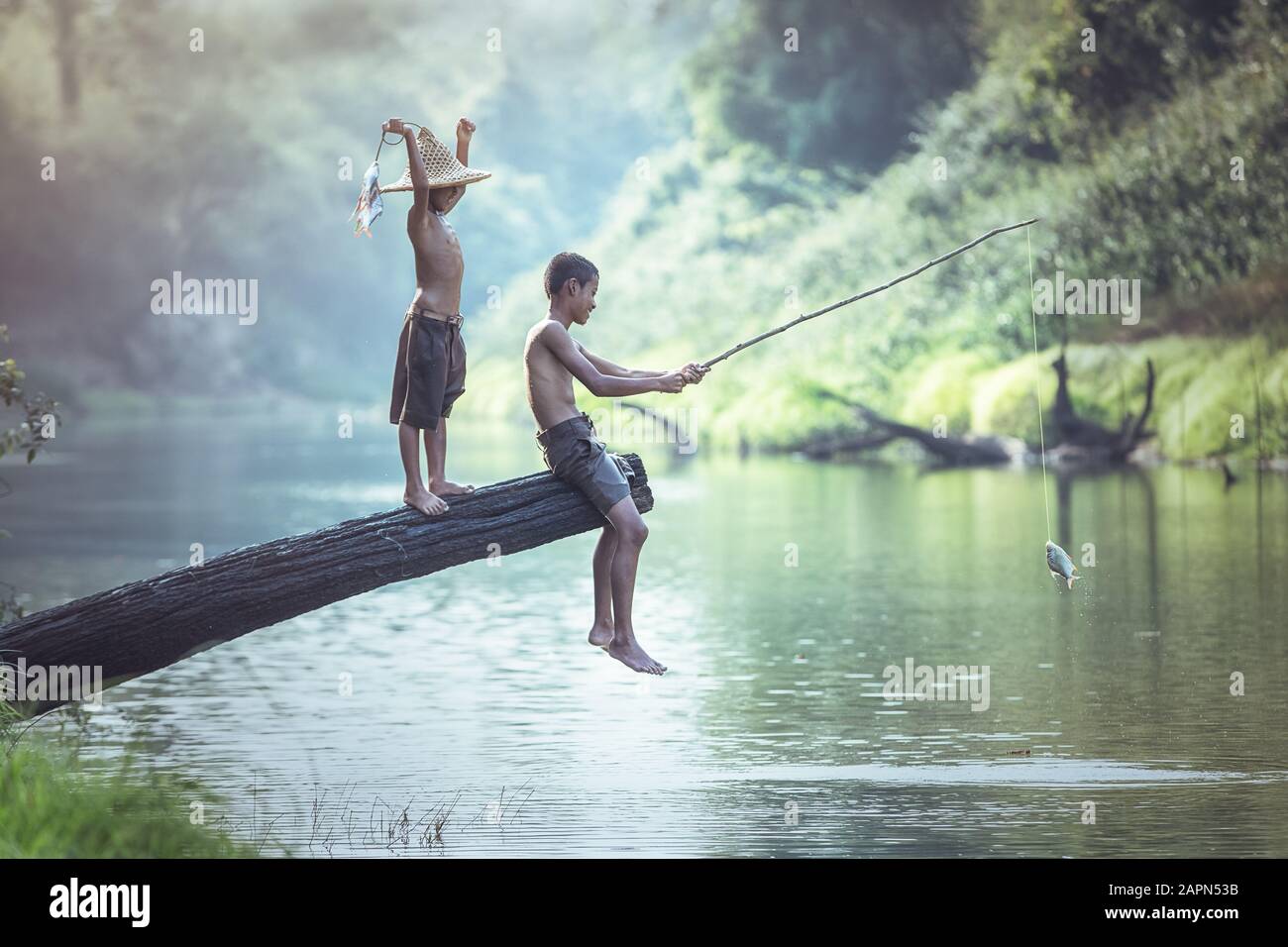 Boy fishing at the river Stock Photo - Alamy