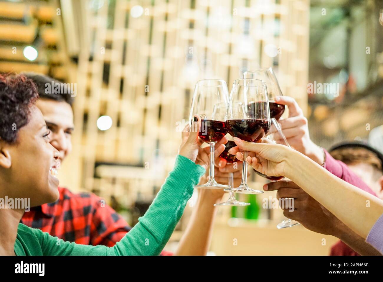 Group of multiracial friends cheering with red wine at pub cocktail bar ...