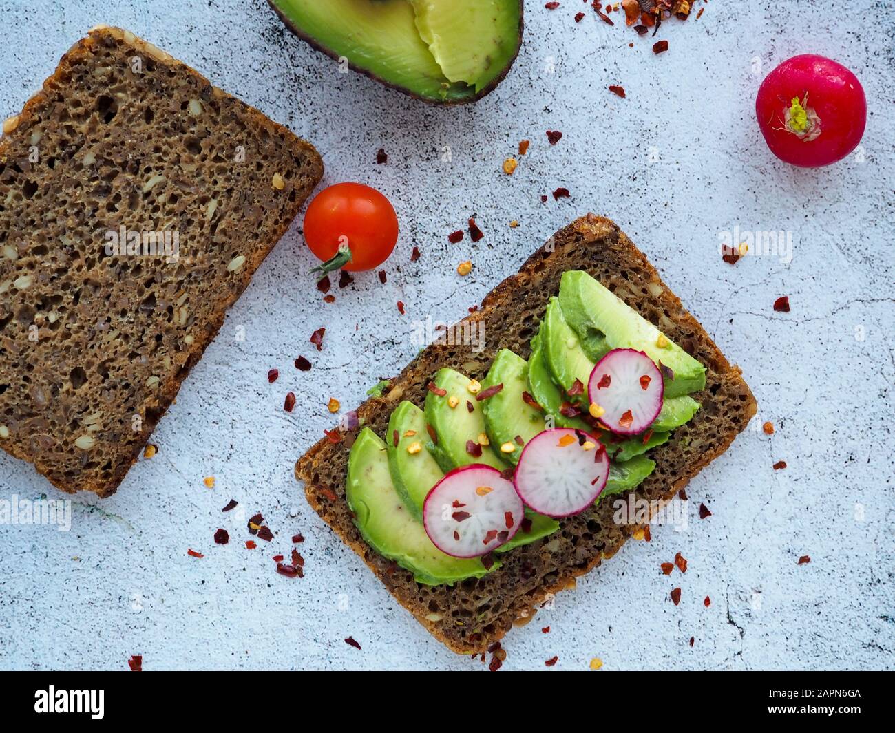 Avocado toast with radish and chili flakes. Healthy lifestyle Stock ...