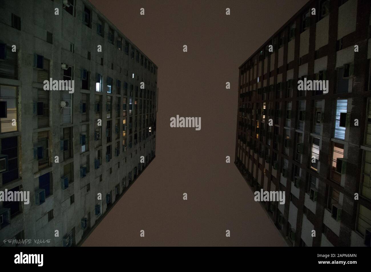 Low angle shot of two buildings facing each other at night in downtown ...