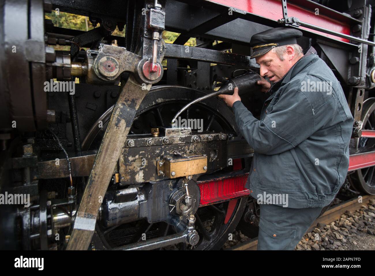 Most na Soči, Slovenia, November 4, 2017: An engine driver greases the ...