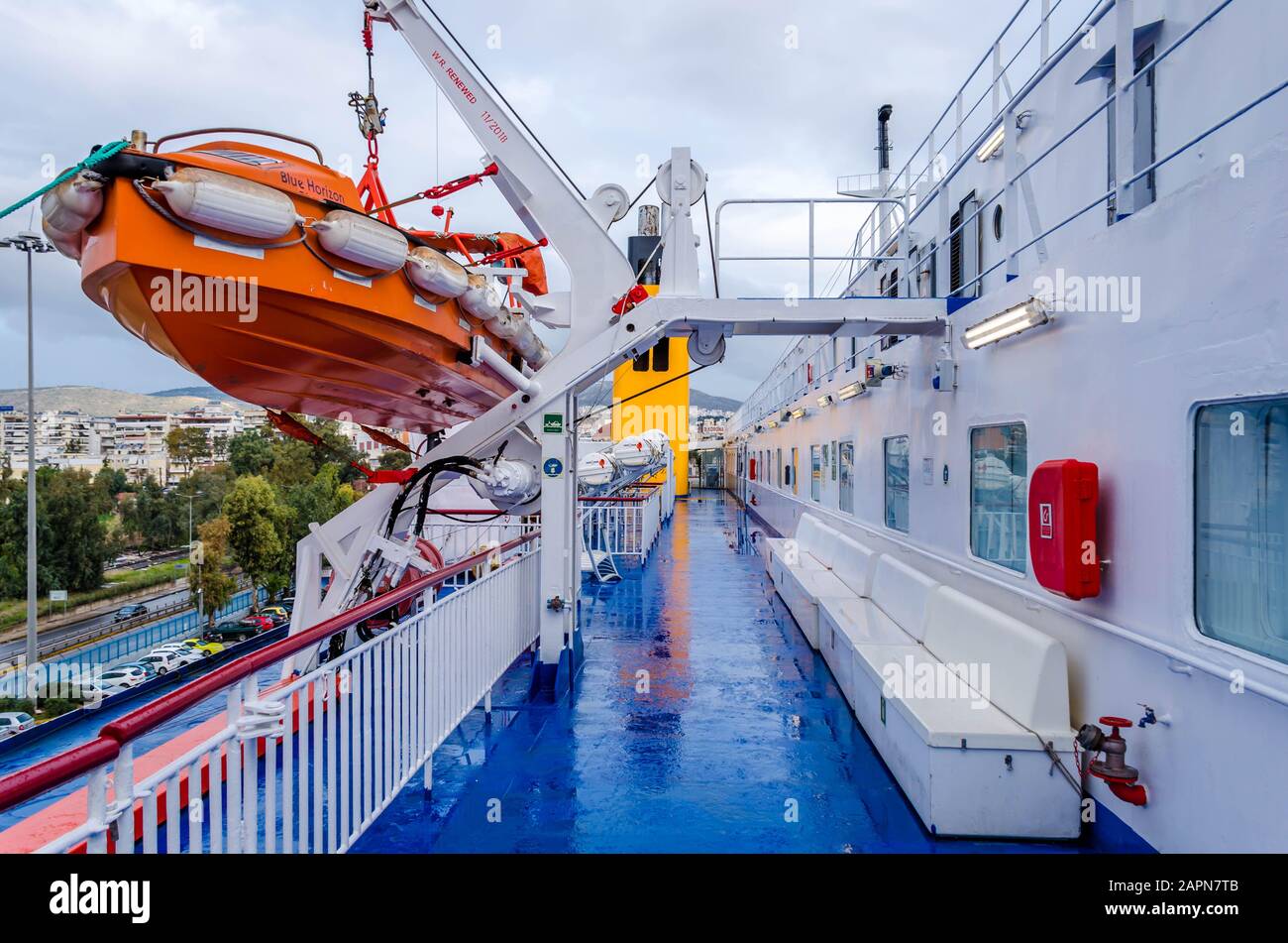 A large rescue boat is attached to the brackets on the deck of the ship ...