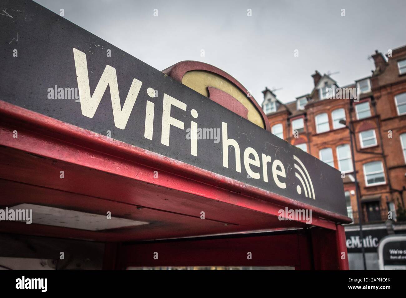 Closeup of WiFi here signage on a phonebox in Finchley, North London ...