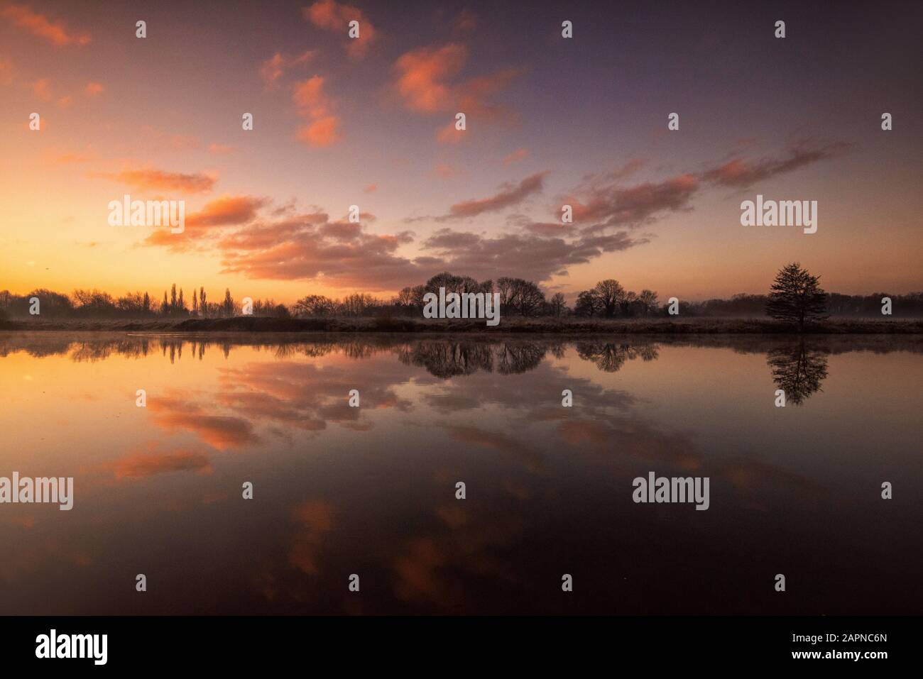 A misty winter sunrise on the River Trent at Colwick Country Park in ...