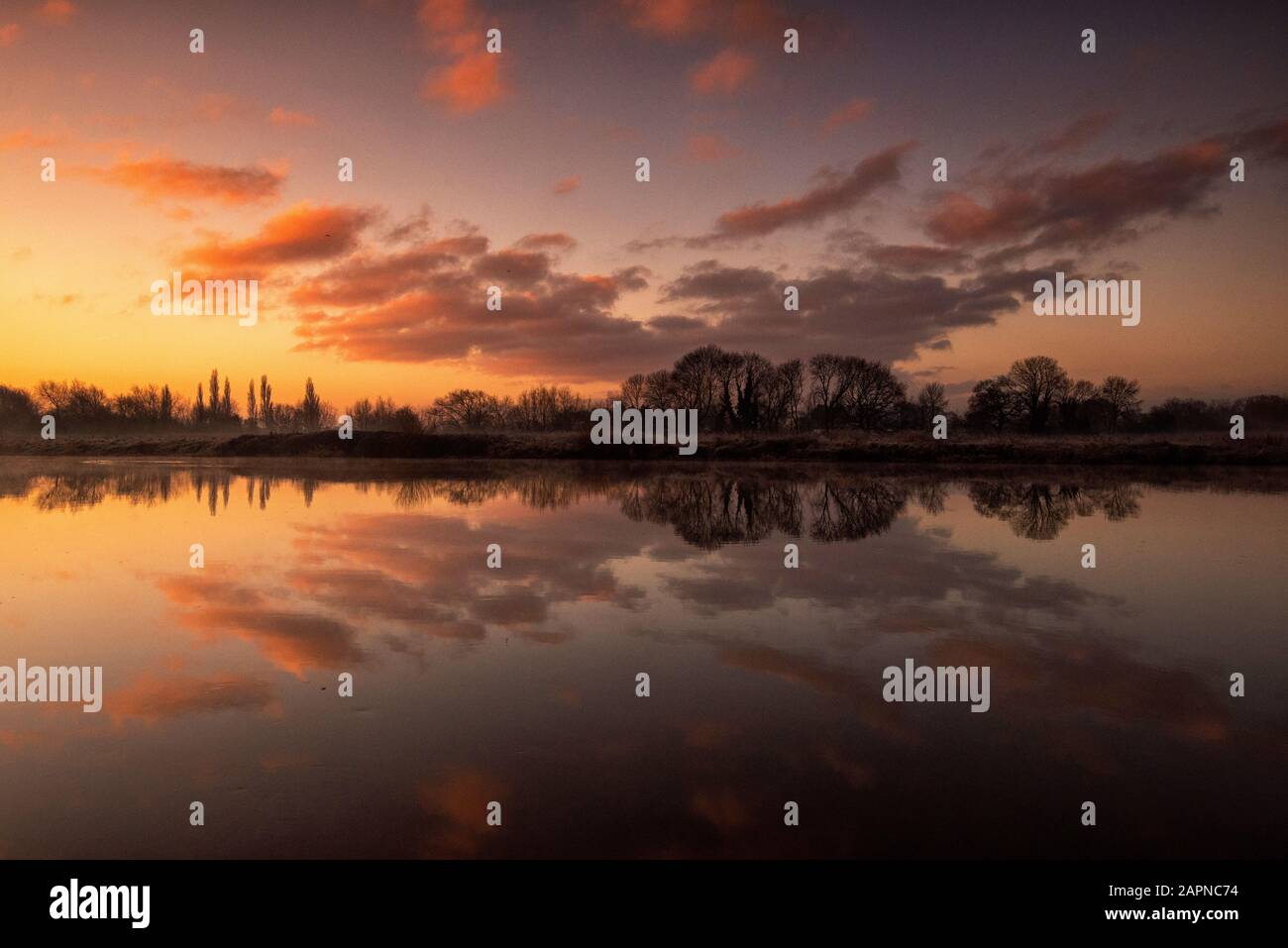 A misty winter sunrise on the River Trent at Colwick Country Park in ...