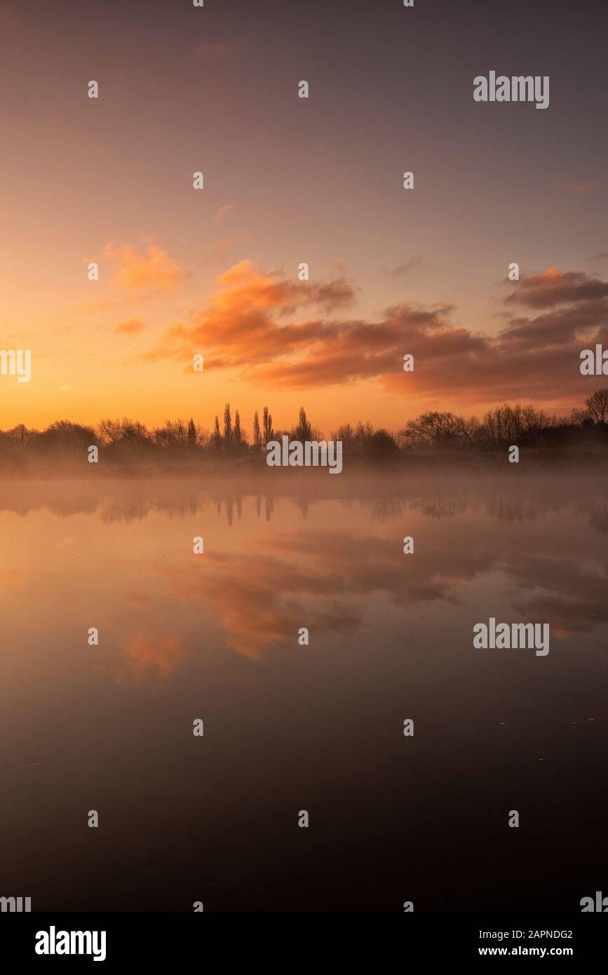 A misty winter sunrise on the River Trent at Colwick Country Park in ...