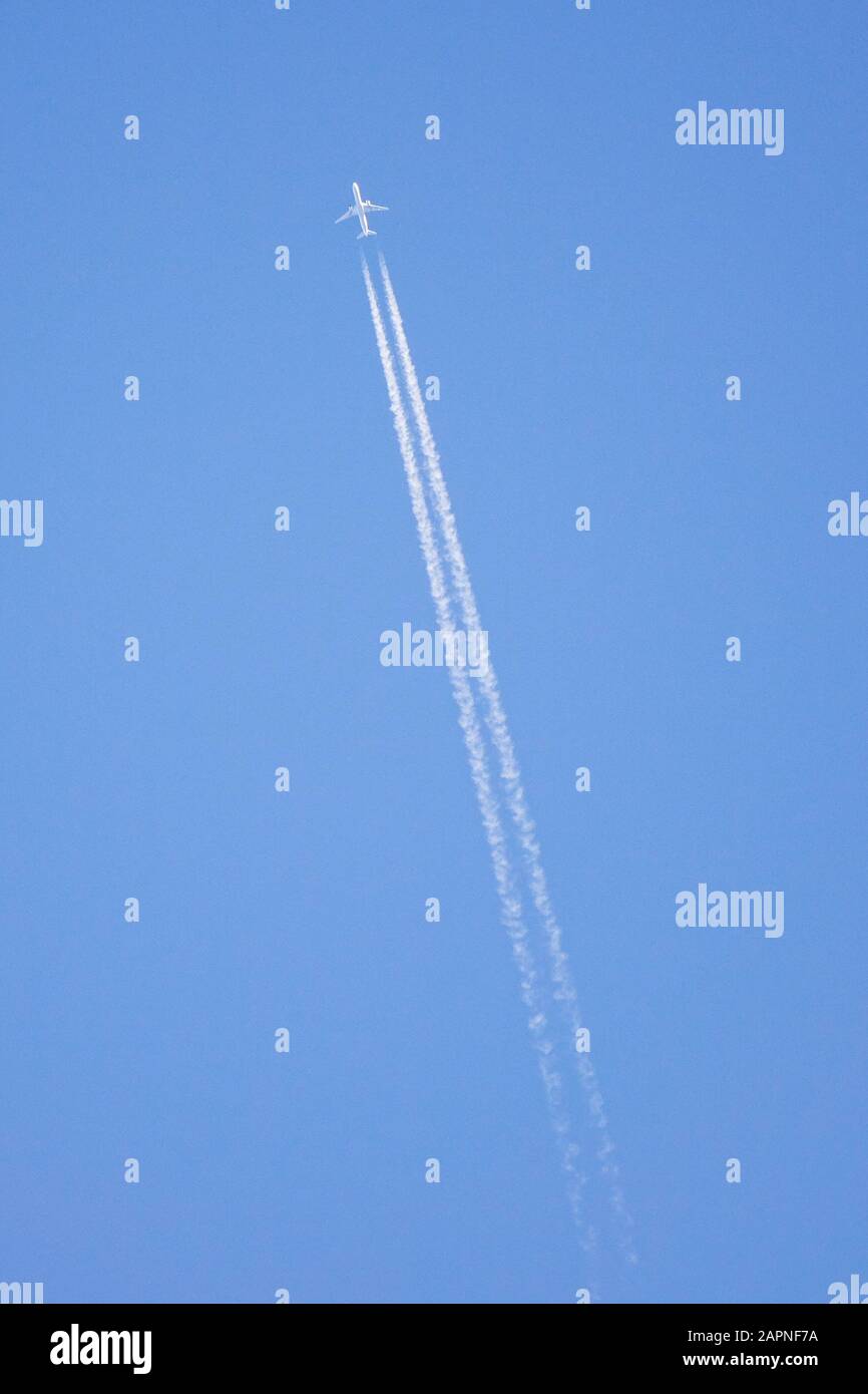 Passenger airplane at cruising altitude against blue sky Stock Photo ...