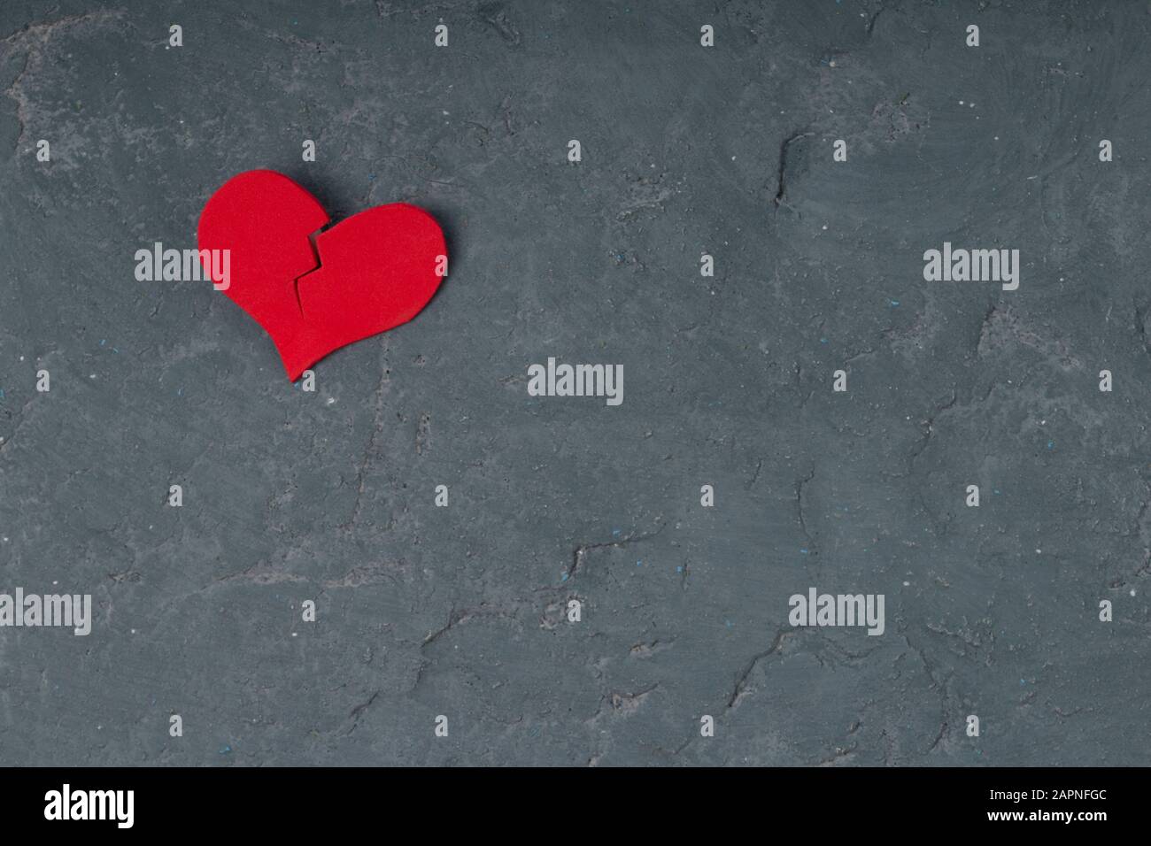 Heart broken on grunge cement wall background - love concept. copy ...