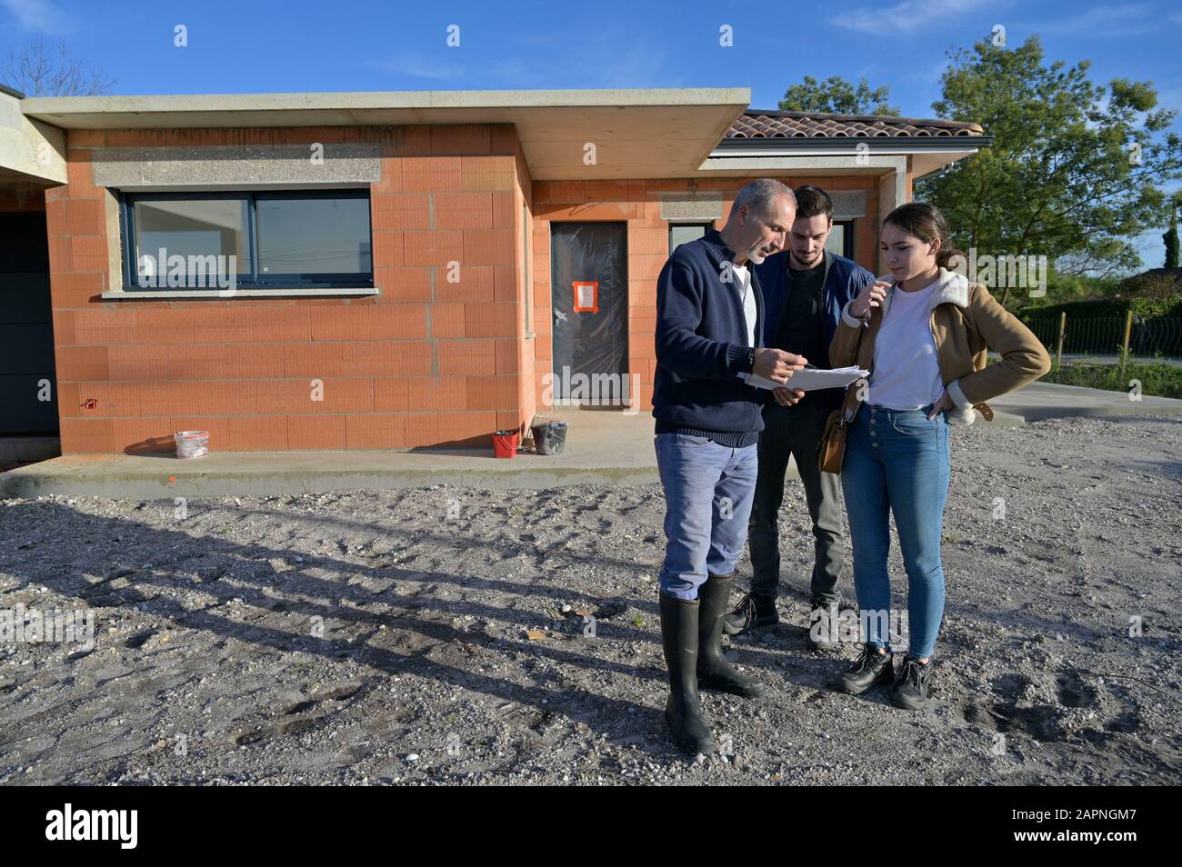 Young couple visiting house under construction Stock Photo - Alamy
