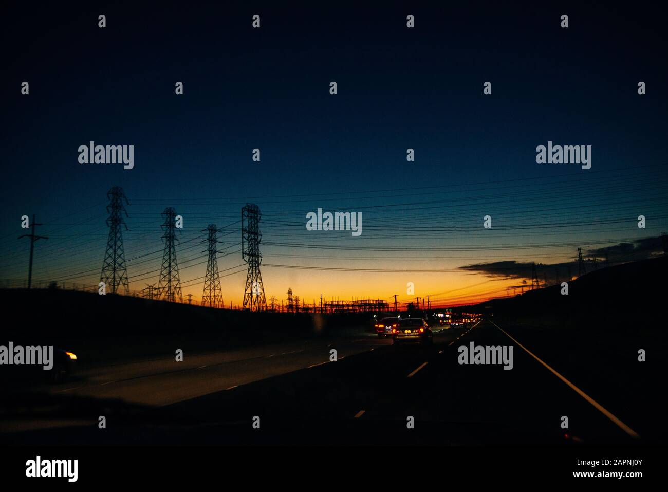 Electric transmission lines against a background of sunset over ...