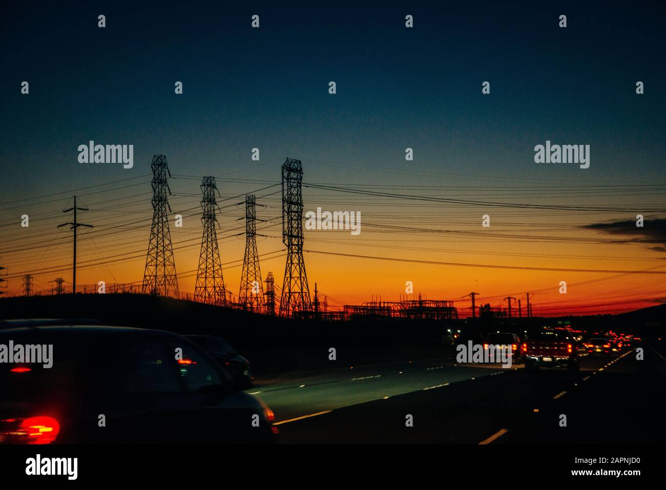 Electric transmission lines against a background of sunset over ...