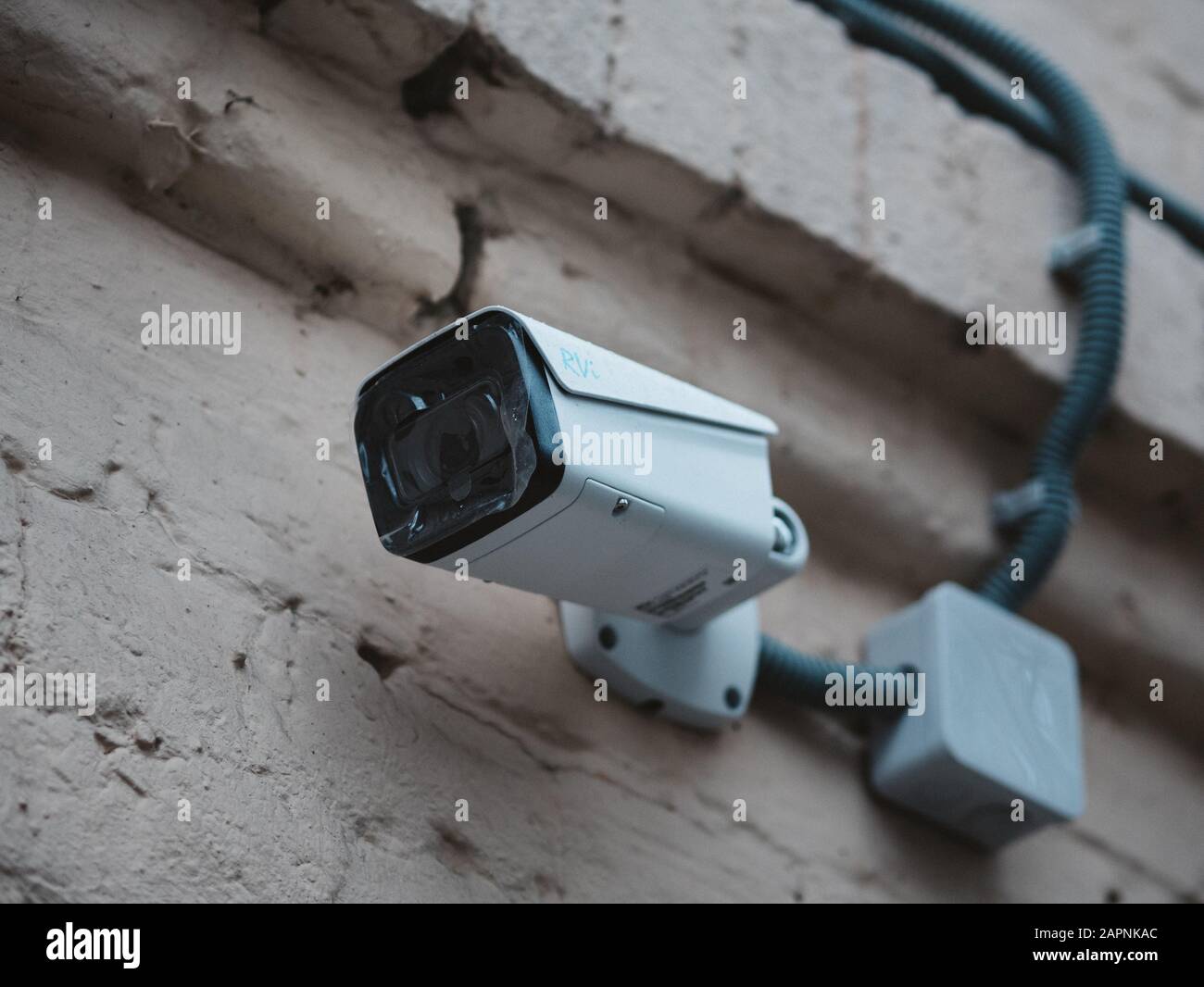 Outdoor CCTV camera mounted on the wall of an old brick house. New ...