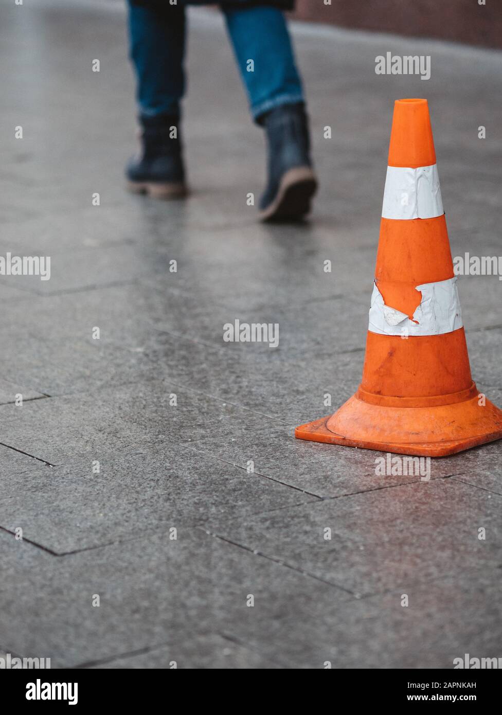 Orange plastic safety cone with strips of retro reflective film on the ...
