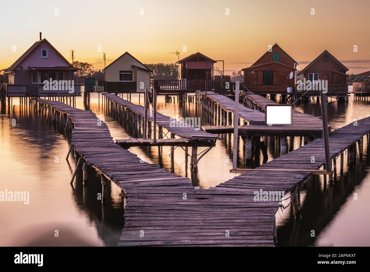 Floating village Bokodi to in Hungary at sunset. These houses belong to ...