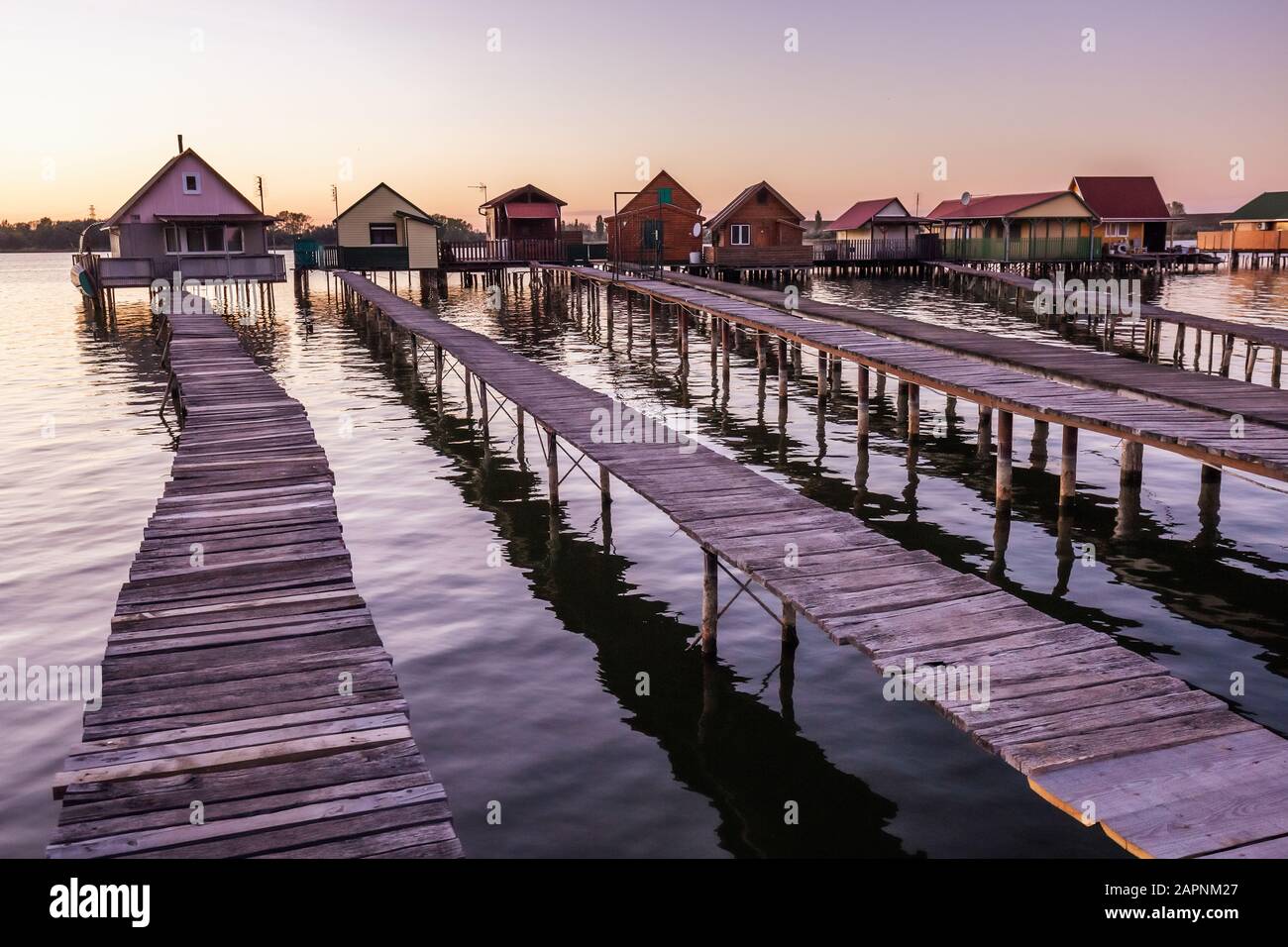 Floating village Bokodi to in Hungary at sunset. These houses belong to ...