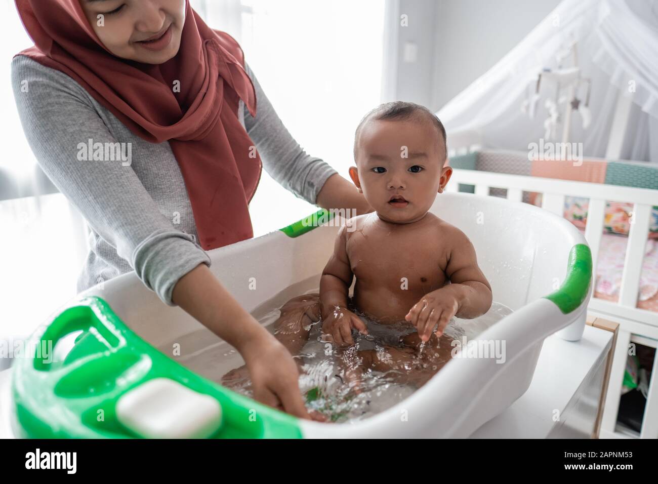 Asian mother bathing her son hi-res stock photography and images - Alamy