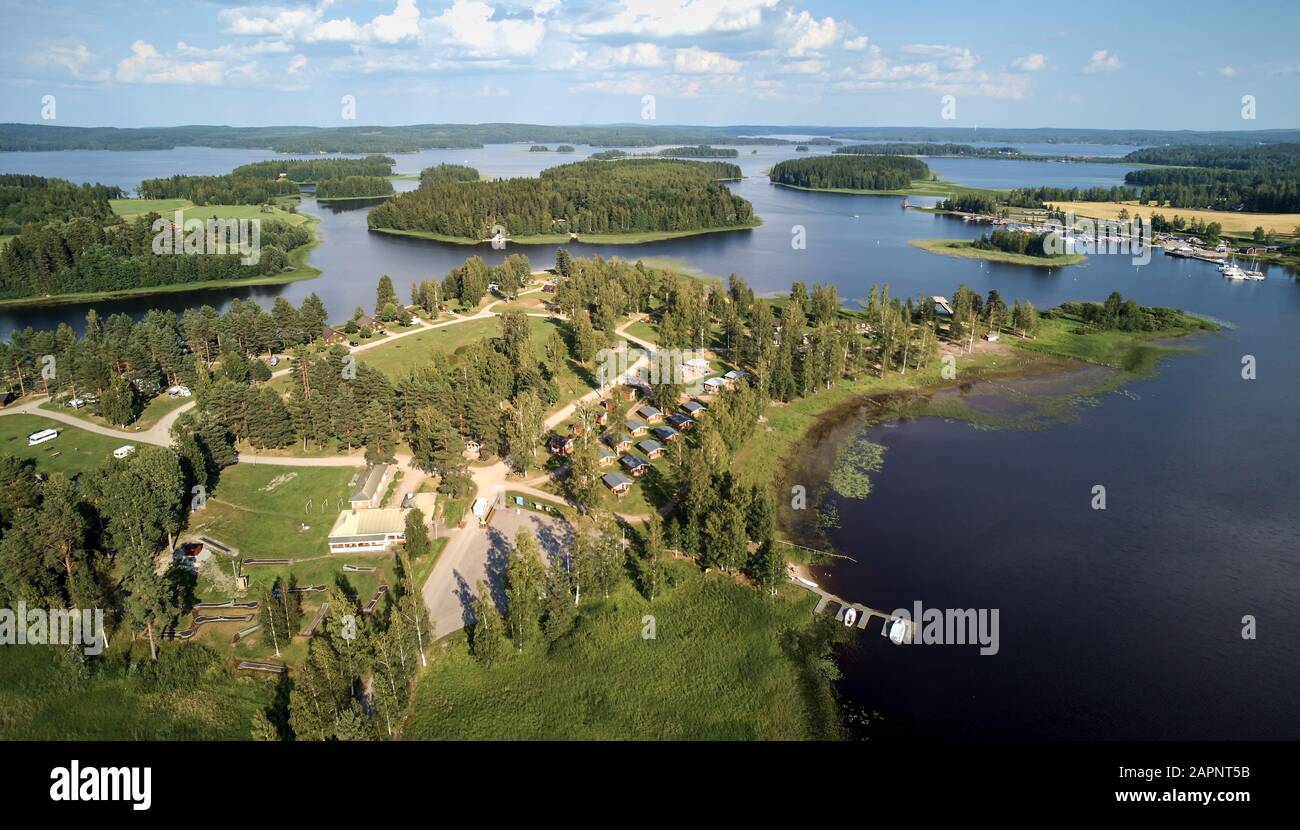 Aerial view of blue lake and green forests on a sunny summer day above ...