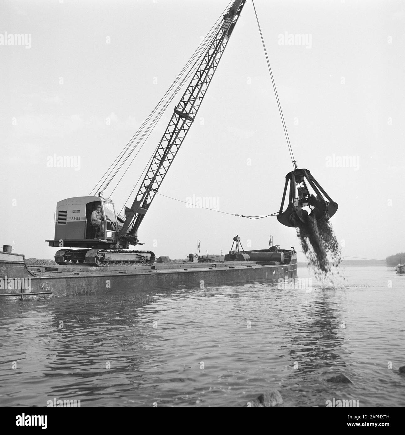 work, water, draglines, boulders, boats, workers Date: undated Location ...