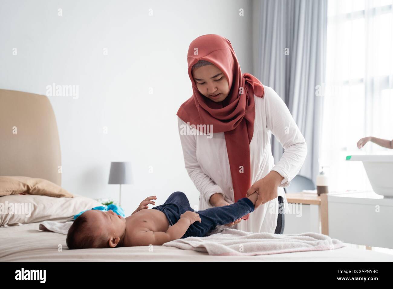 Mother changing nappy diaper toddler hi-res stock photography and ...