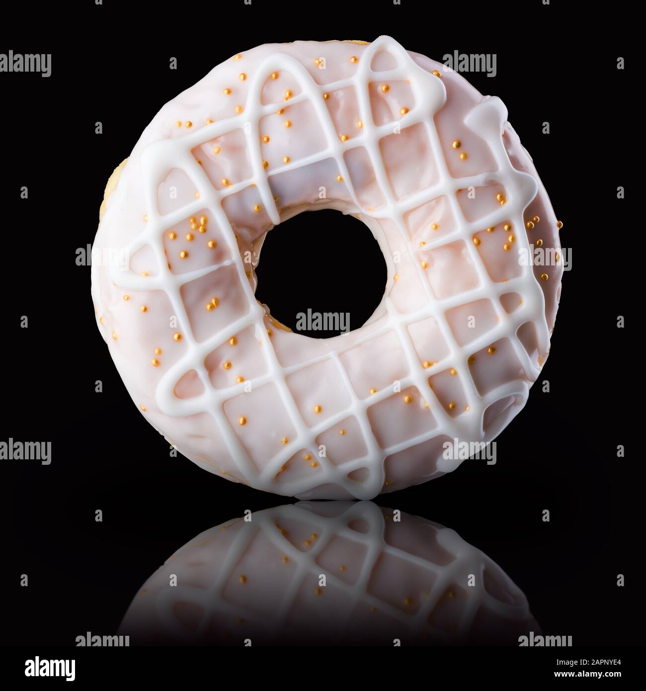 White chocolate donut isolated on a black background with reflection ...